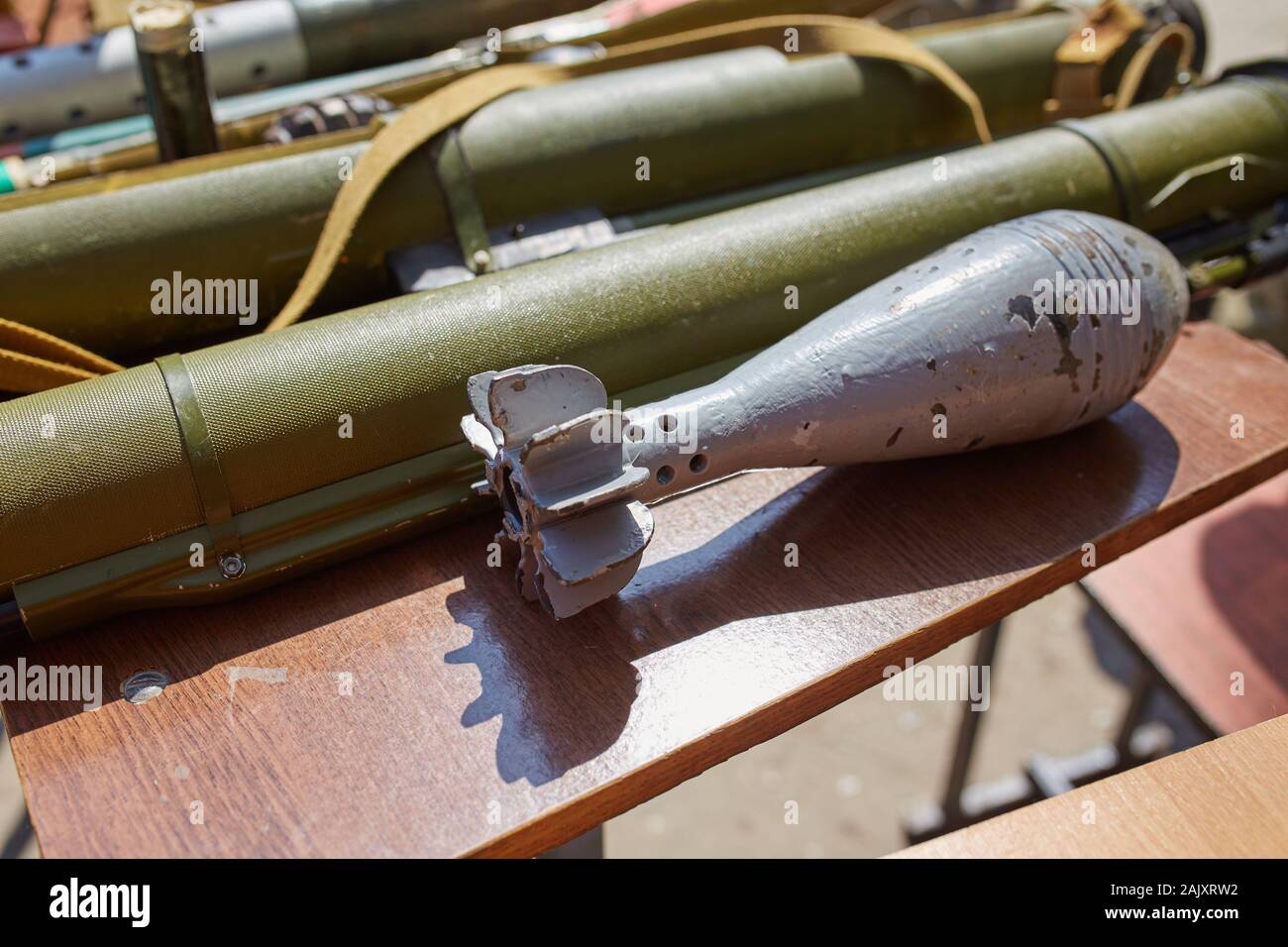A mortar mine and a hand grenade launcher at the stand. Weapons of war ...