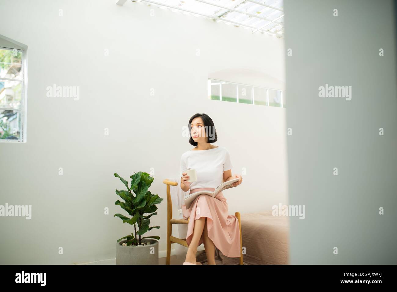 Young woman chilling at home in chair Stock Photo - Alamy