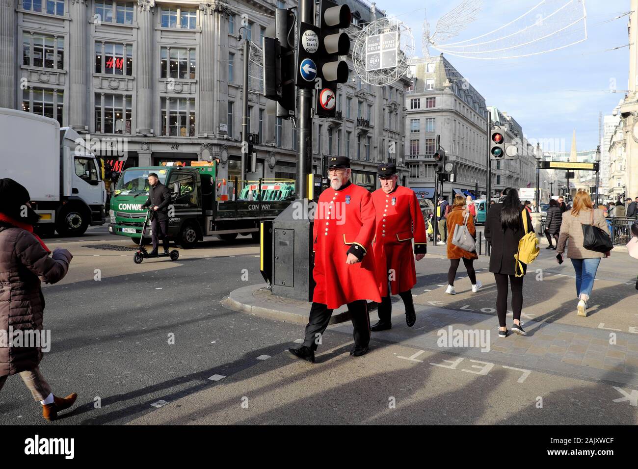 Chelsea Pensioners in red coats crossing Oxford Street at Oxford Circus ...
