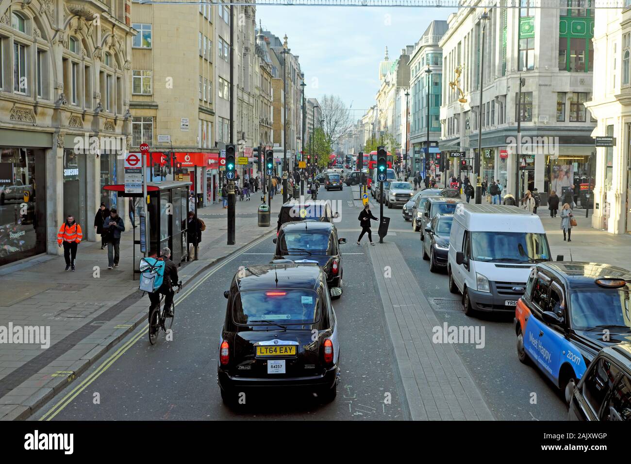 View of taxis, cyclist, traffic queue and people walking on Oxford ...