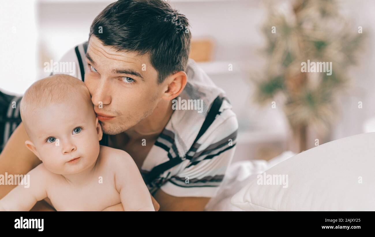 Young father playing with child on couch Stock Photo - Alamy