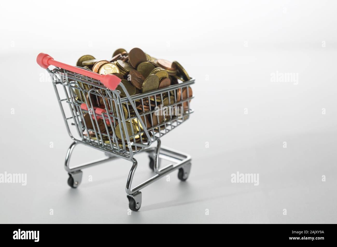 Three-Quarter Back View of Tiny Shopping Trolley Full of Euro Coins on ...