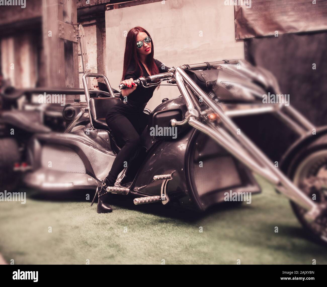 stylish young woman model posing near a chic tricycle Stock Photo - Alamy