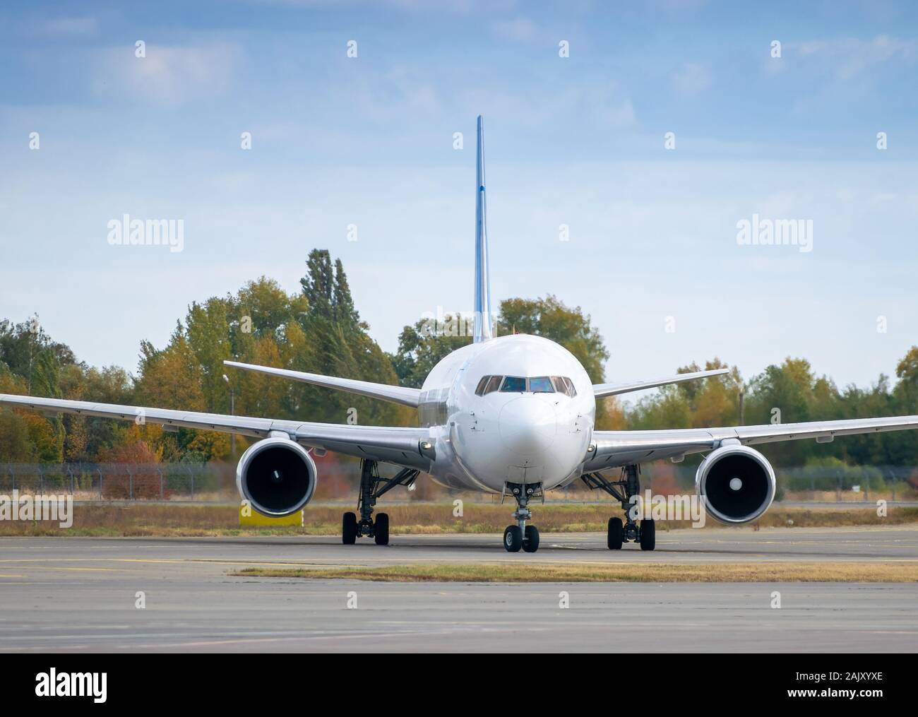 Passenger plane front view taxiing in the airport Stock Photo - Alamy