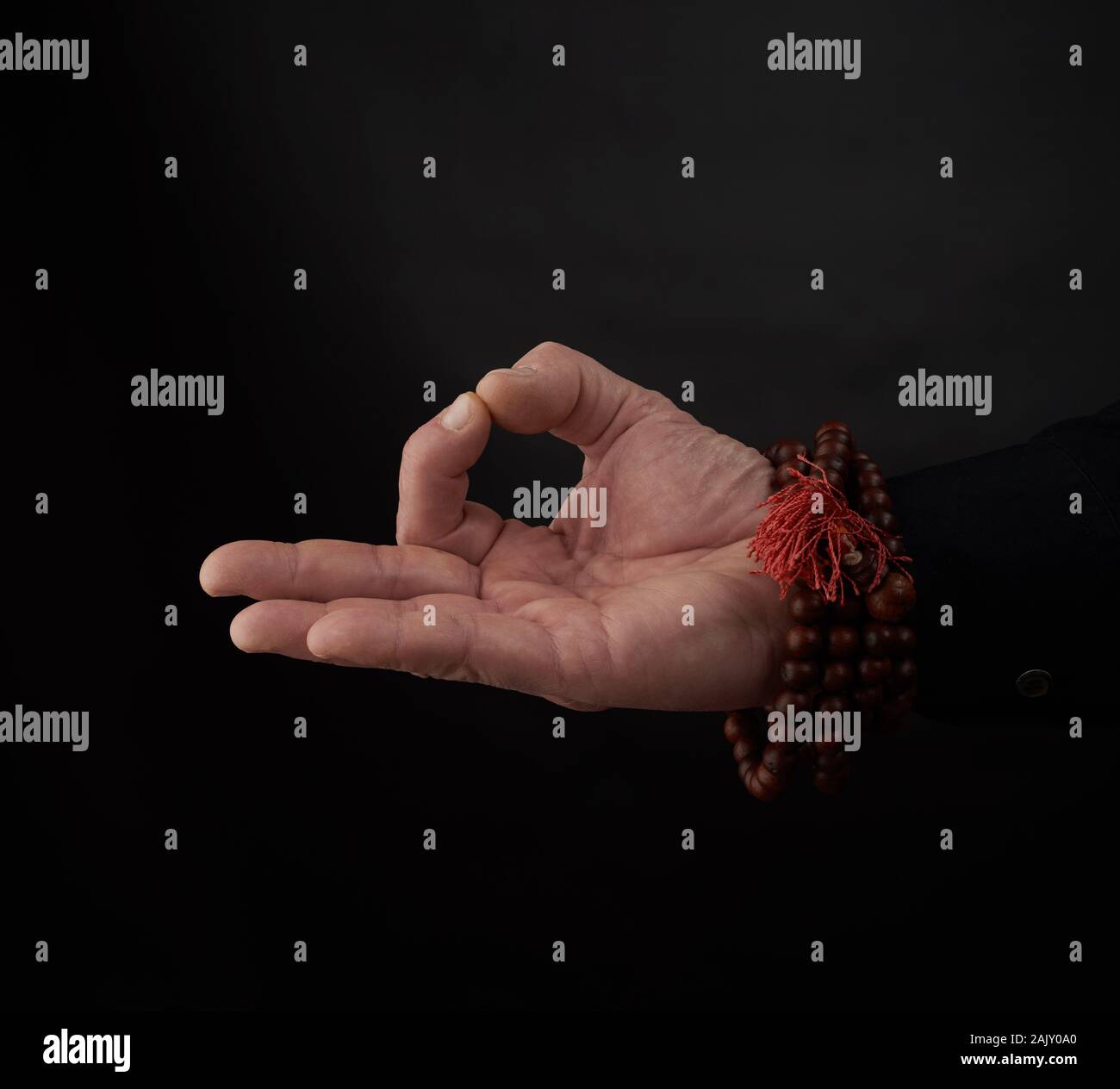 male hand shows the mudra of Knowledge on a black background, the ...