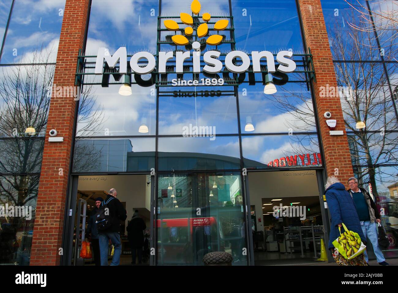 Shoppers with shopping bags outside a branch of Morrisons supermarket ...