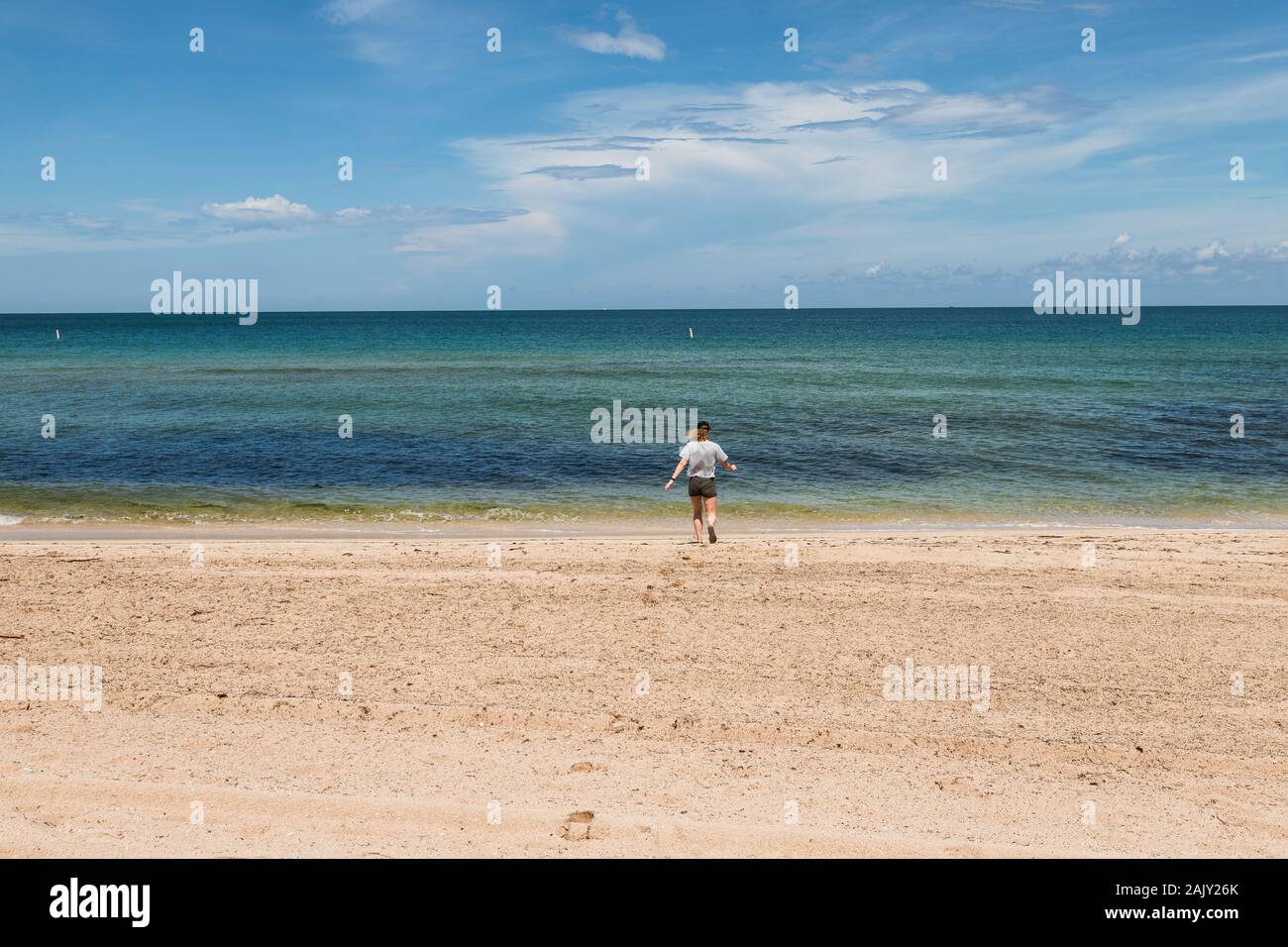 Girl enjoying scenic empty beaches in North Miami Beach during a ...