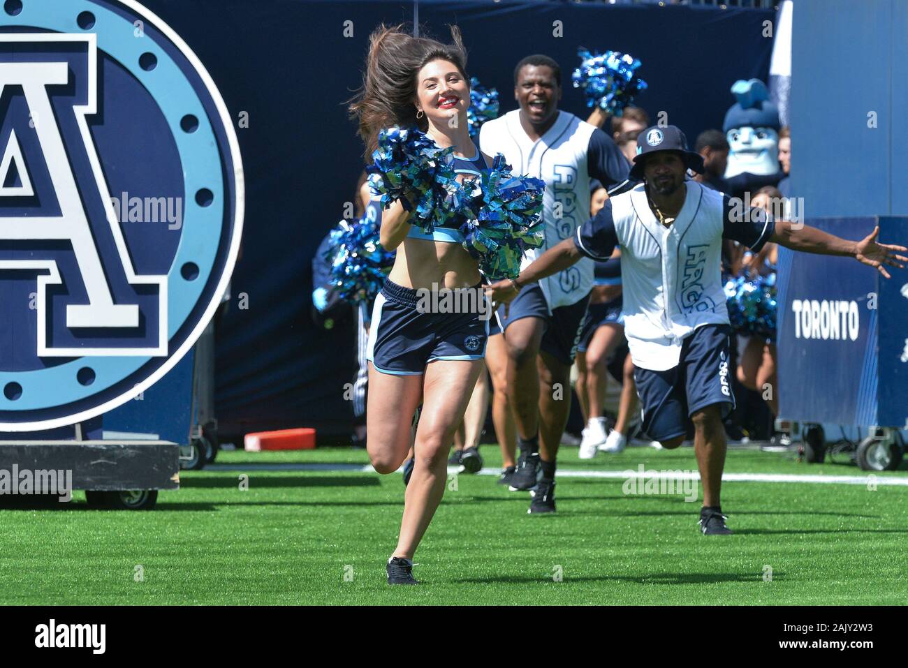Toronto Argonauts cheerleaders run on the field before rhe game start ...