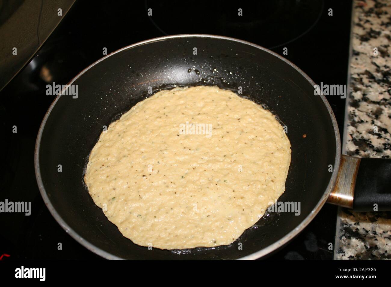 A pancake is being cooked on an old frying pan Stock Photo - Alamy