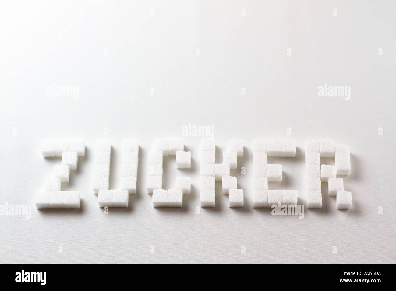 "Sugar" (Zucker in German) spelled with pixel art letters made out of ...