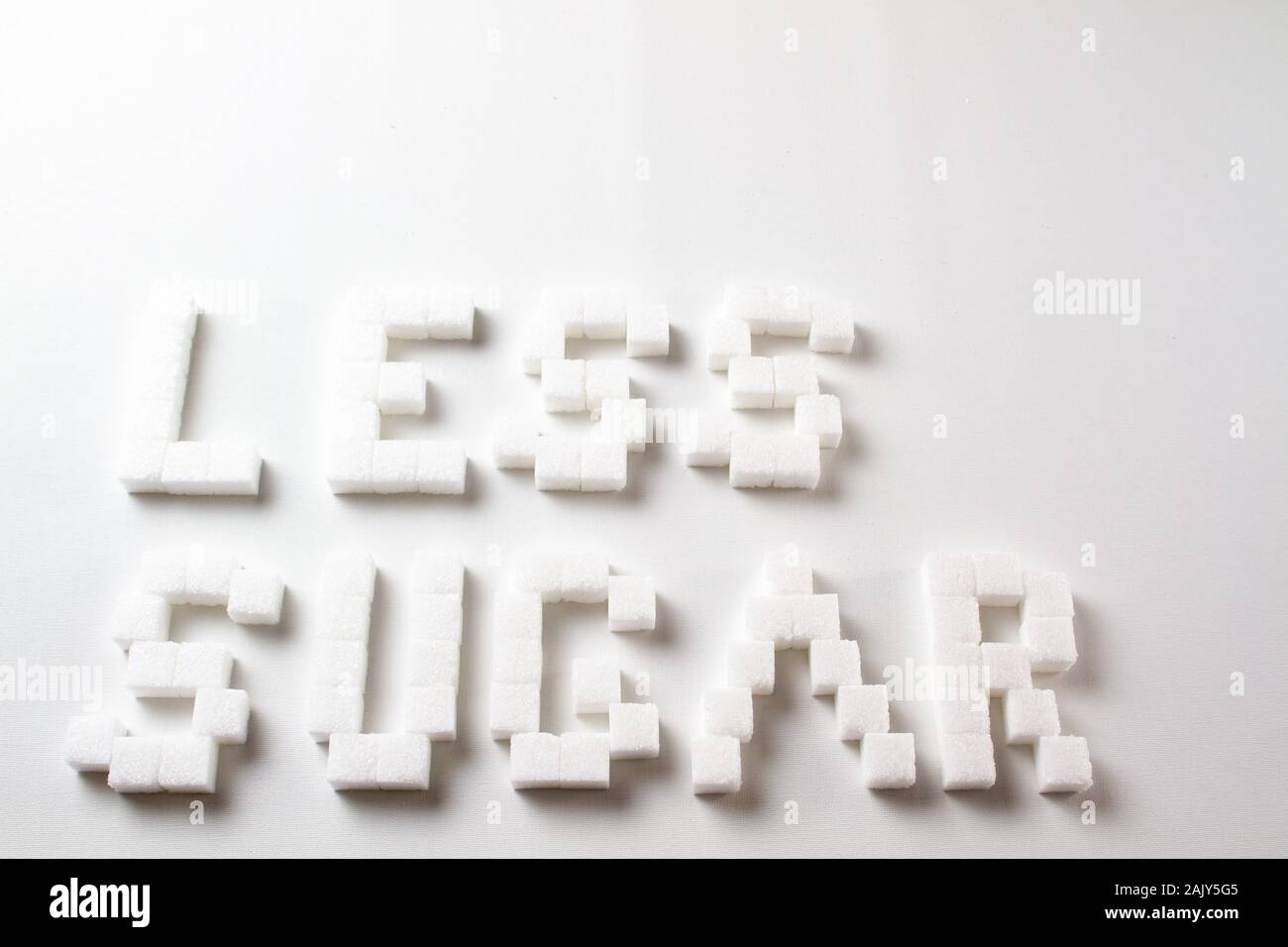 "Less sugar" spelled with pixel art letters made out of sugar cubes on ...