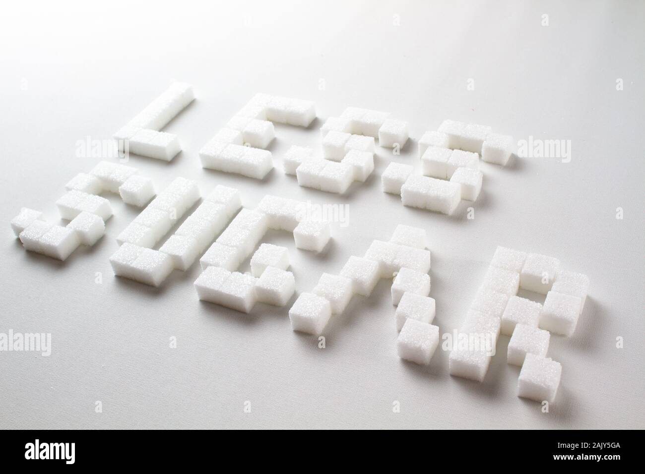 "Less sugar" spelled with pixel art letters made out of sugar cubes on ...