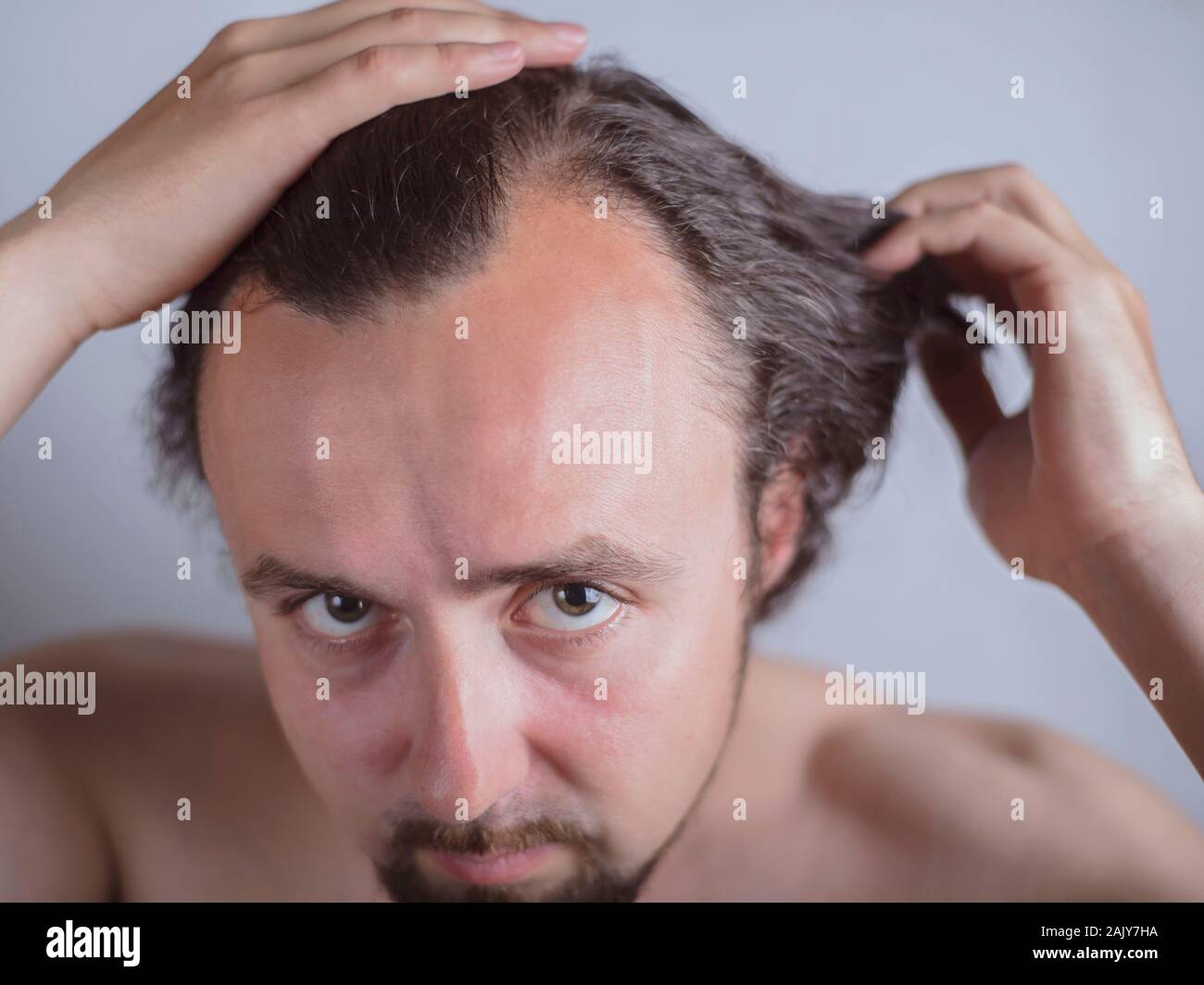 Portrait of a young guy with magnificent hair that falls early on his ...
