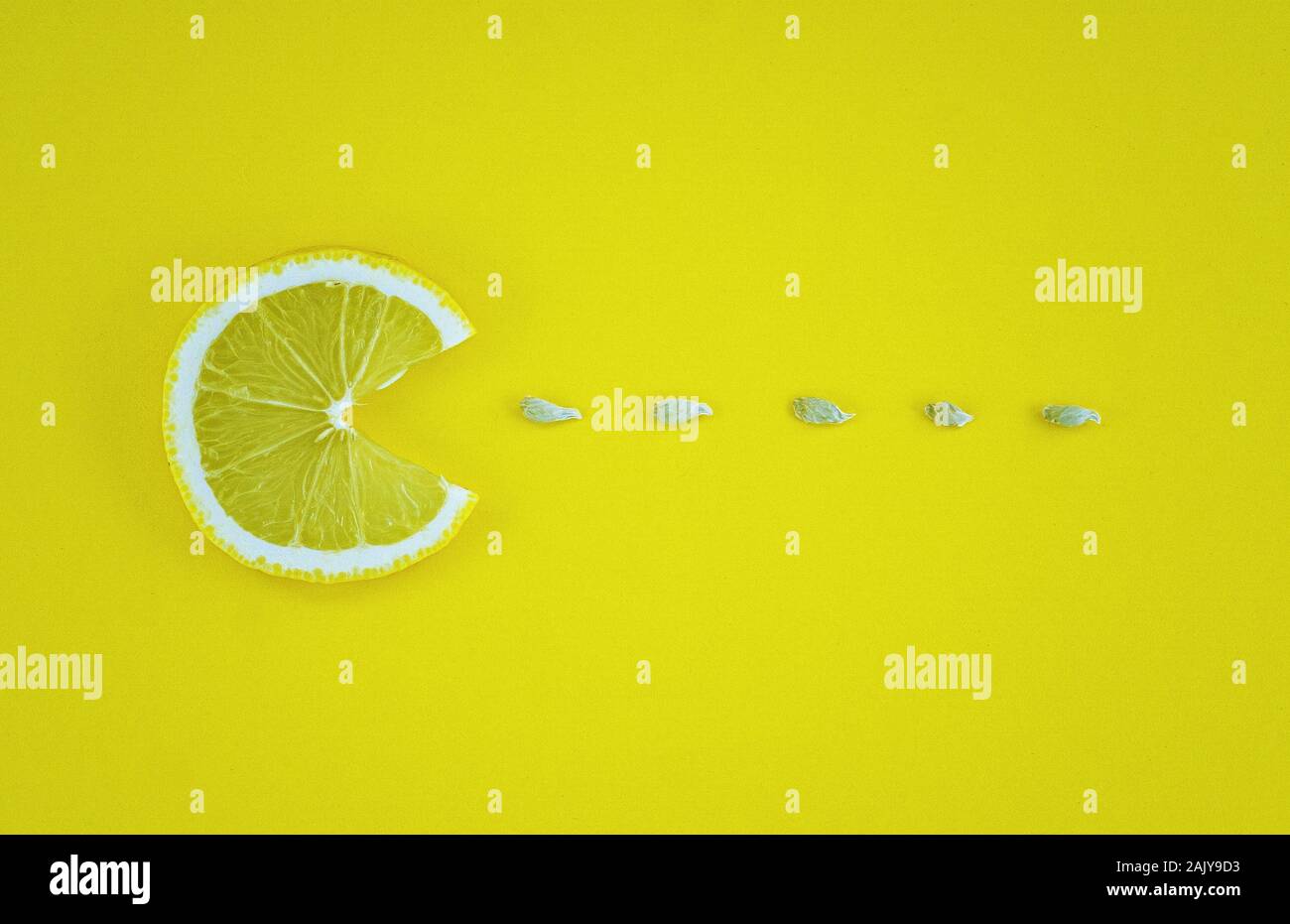 Creative photography slice of lemon Pac Man shape eating lemon seeds ...
