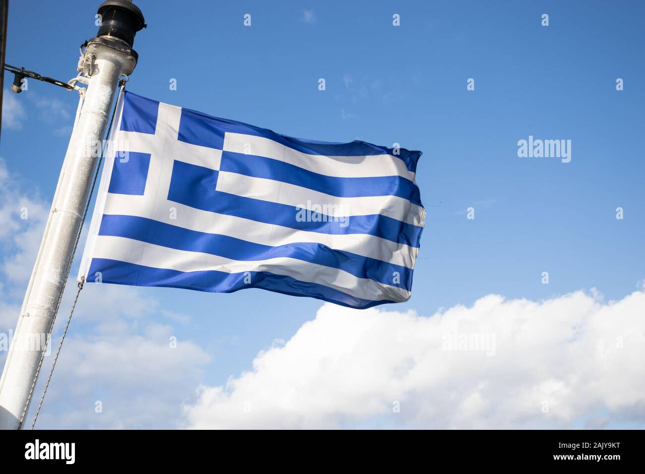 Waving greek flag on a sunny day against the sky Stock Photo - Alamy