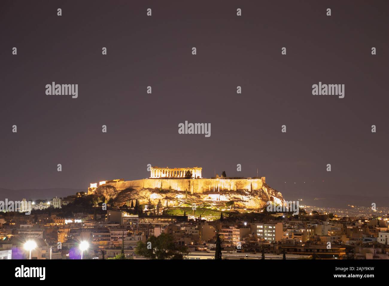 Night view of acropolis building on a hill with lights and beautiful ...