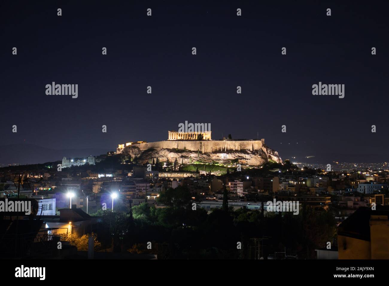 Night view of acropolis building on a hill with lights and beautiful ...