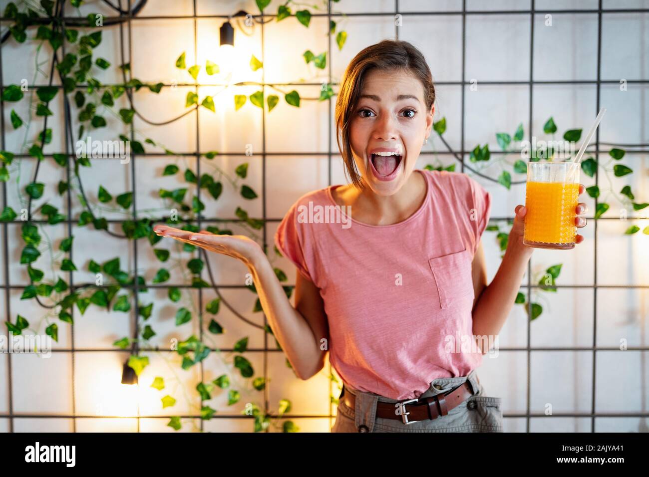 Young beautiful woman enjoying a healthy raw fruit juice Stock Photo ...