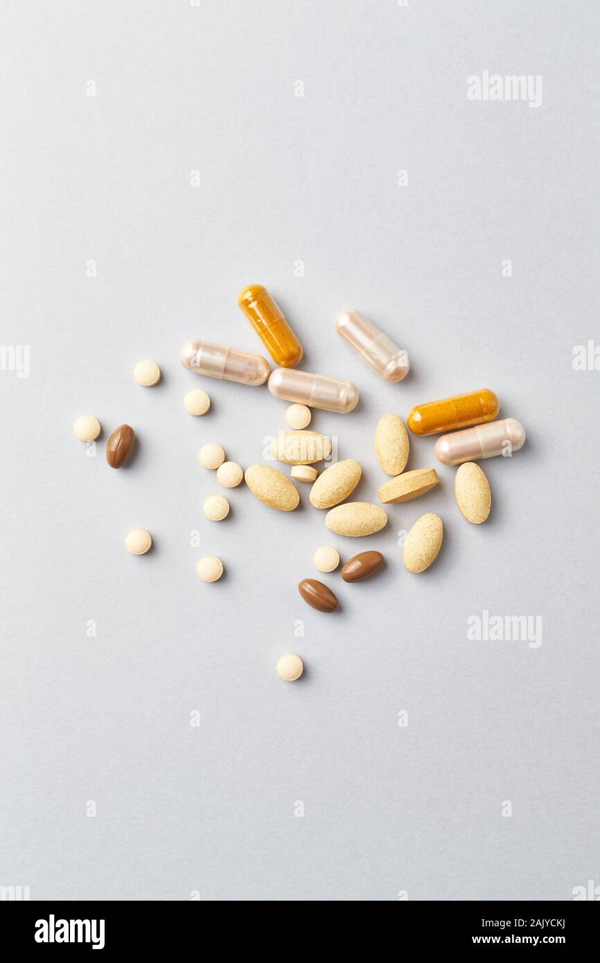 Vitamins and supplements on bright paper background. Concept for a ...