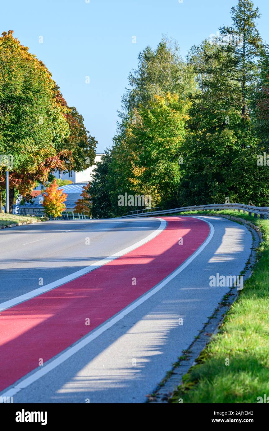 Colour-coded cycle path on a public road Stock Photo - Alamy