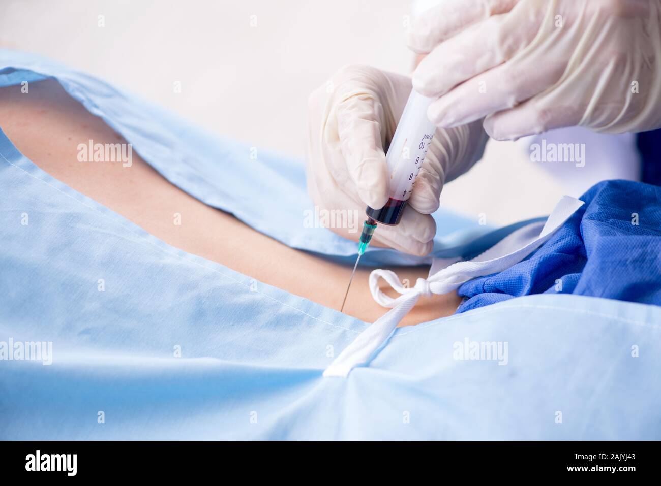 The female patient getting an injection in the clinic Stock Photo - Alamy