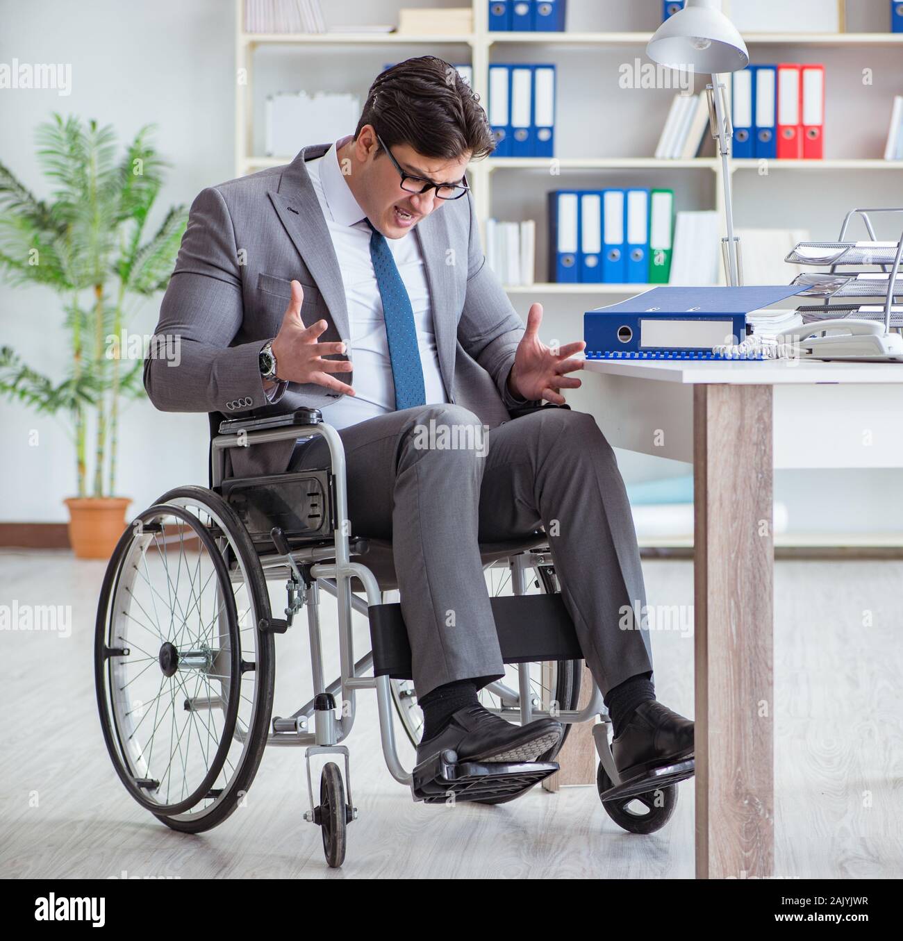The disabled businessman working in the office Stock Photo - Alamy