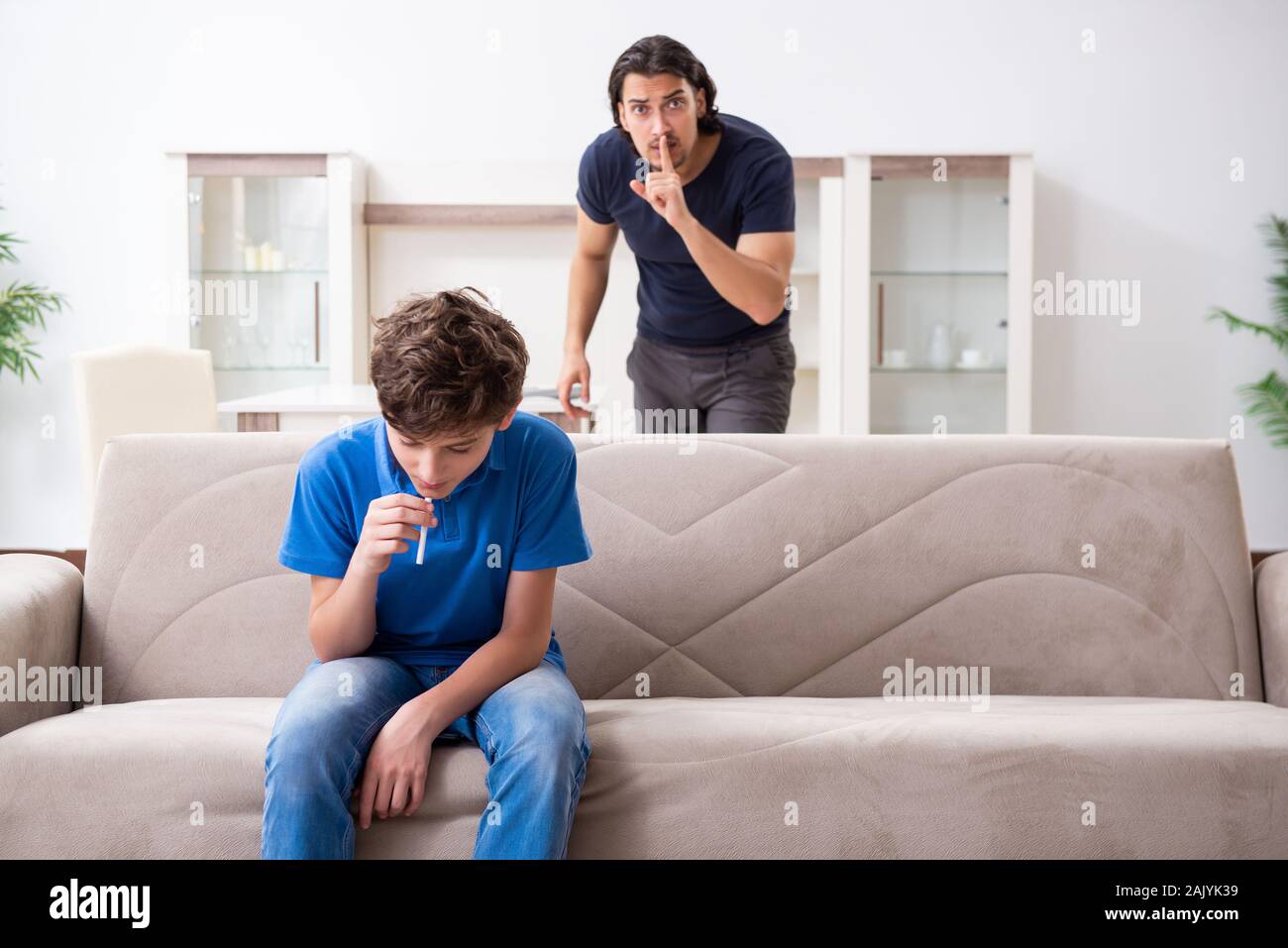 The concept of underage smoking with young boy and family Stock Photo ...