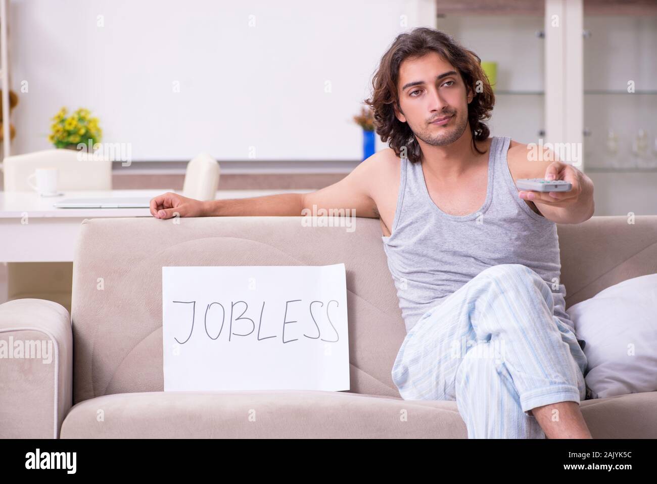 Unemployed man watching tv hi-res stock photography and images - Alamy