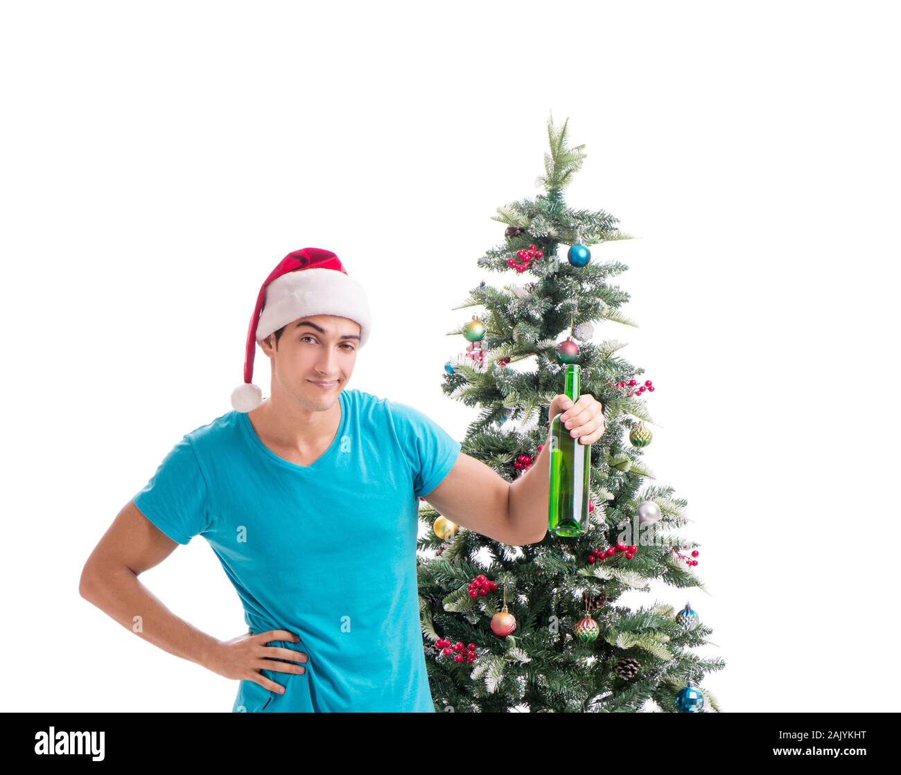 The young man decorating christmas tree isolated on white Stock Photo ...