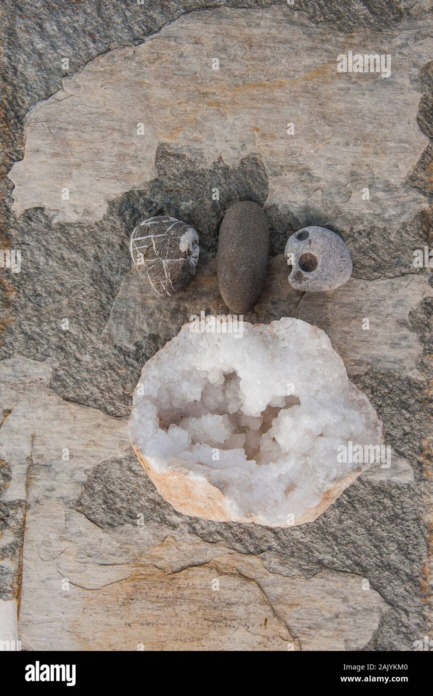 Crystal Geode and river stones on rock slab Stock Photo - Alamy