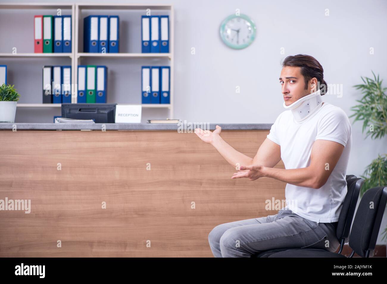 Clinic reception counter and young patient Stock Photo - Alamy