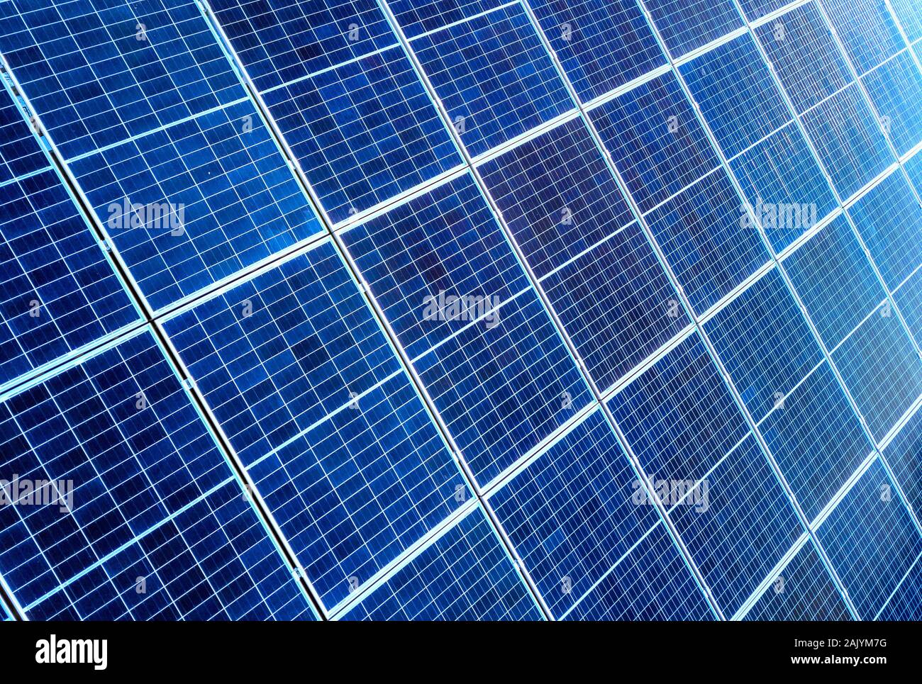 Close-up surface of lit by sun blue shiny solar photo voltaic panels ...
