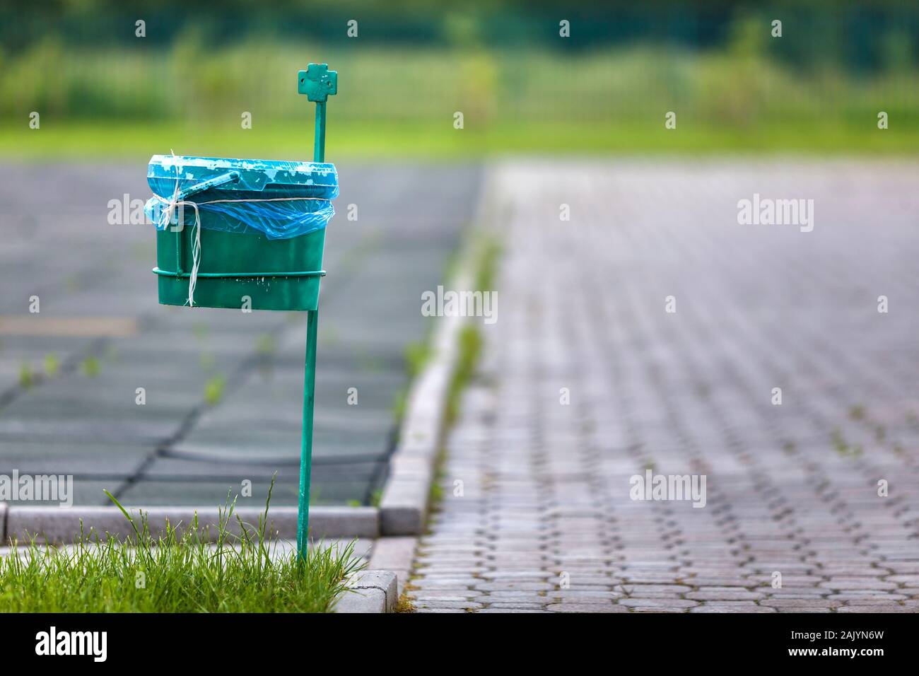 Garbage bin outdoor on blurred sunny background Stock Photo - Alamy