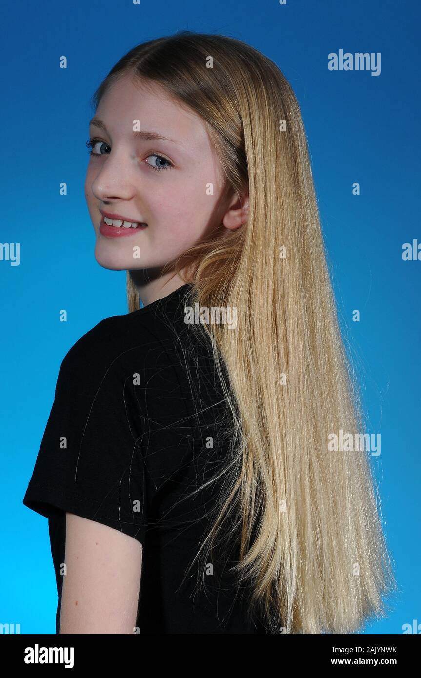 Pretty Blonde Haired Caucasian Teenage Girl In A Black T Shirt Isolated