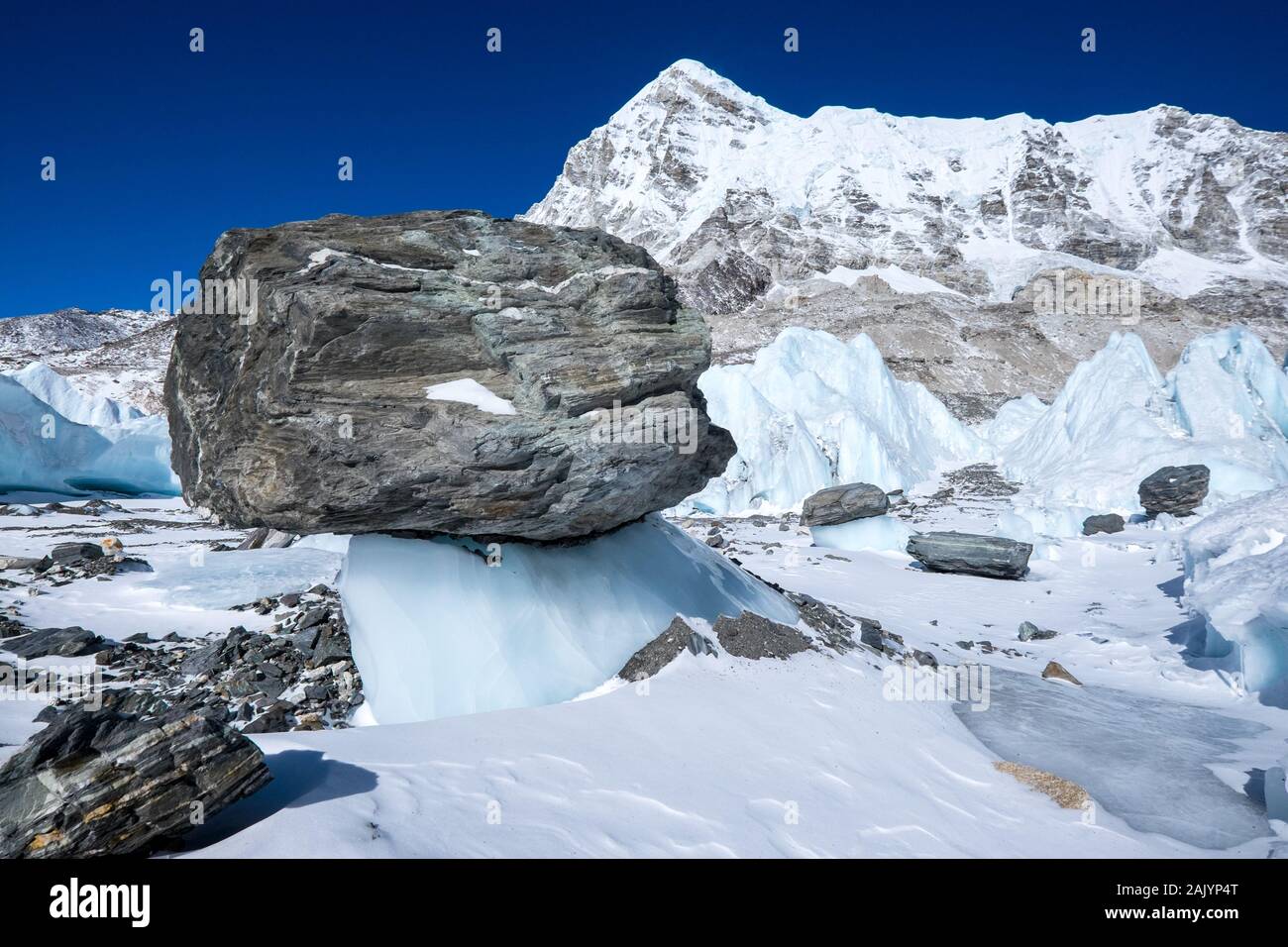 Glacial Erratic boulders left perched on a column of melting ice, Khumbu Glacier, Nepal ...