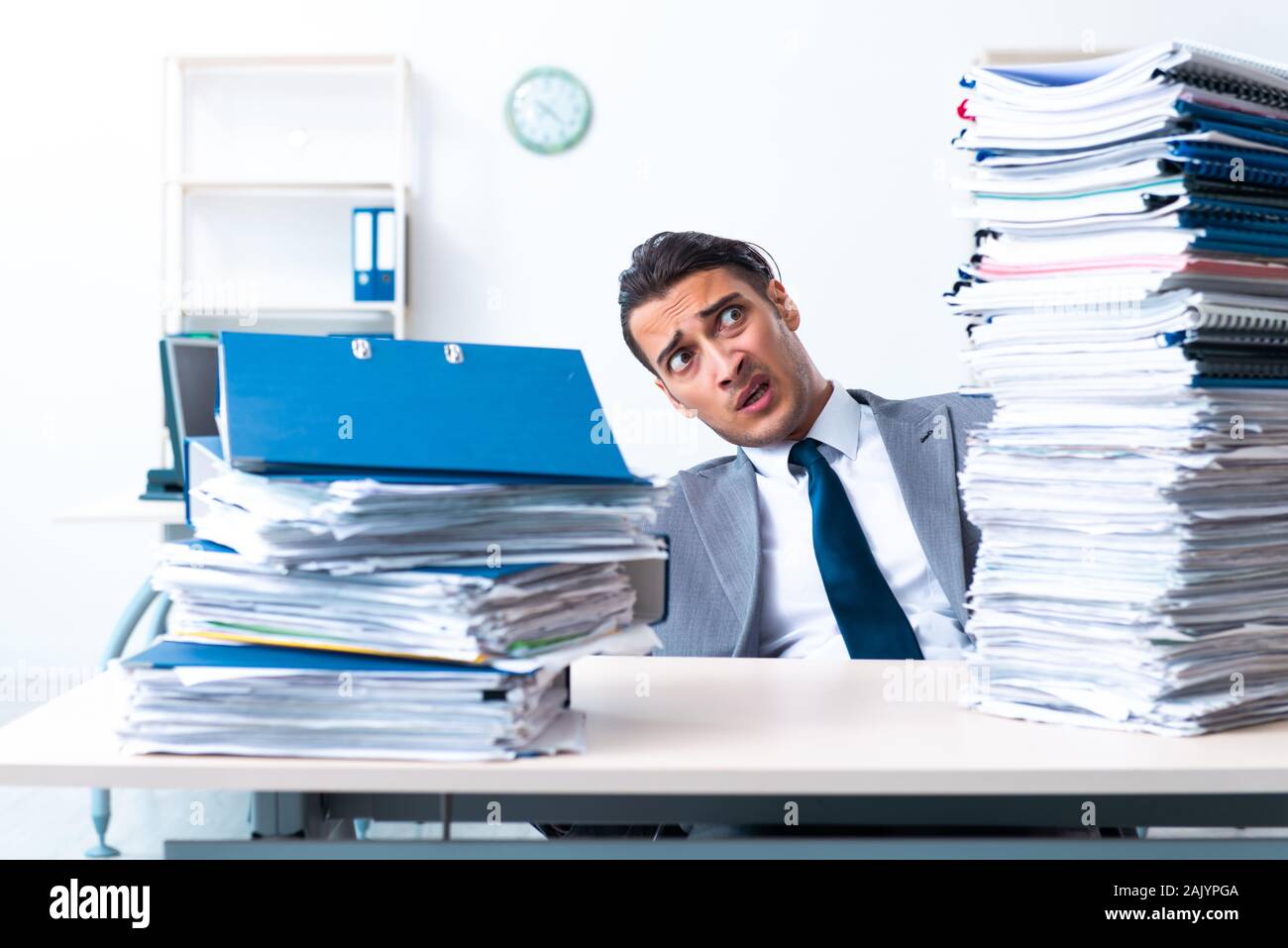 The businessman with heavy paperwork workload Stock Photo - Alamy