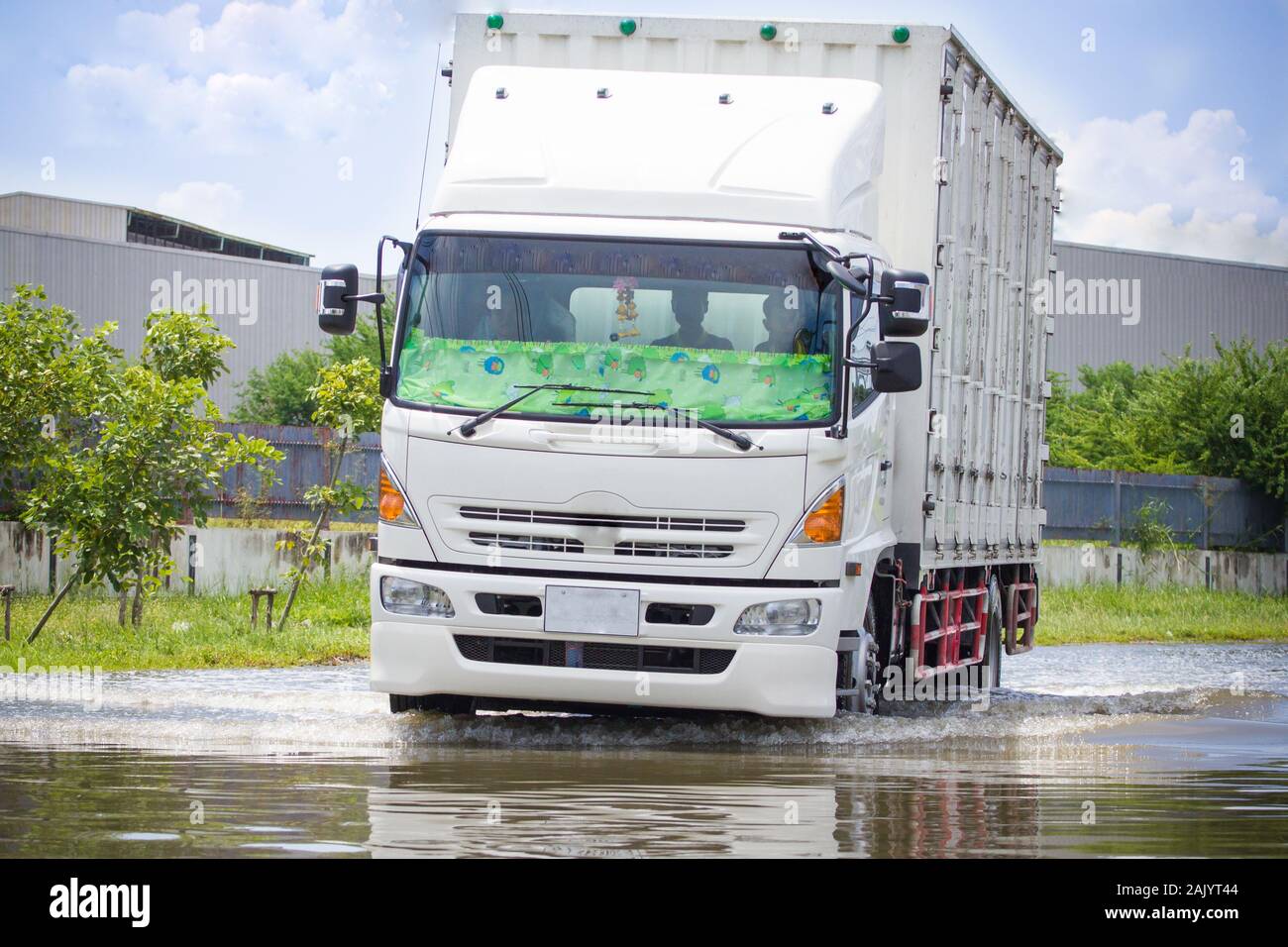 Splash by a truck as it goes through flood water Stock Photo - Alamy