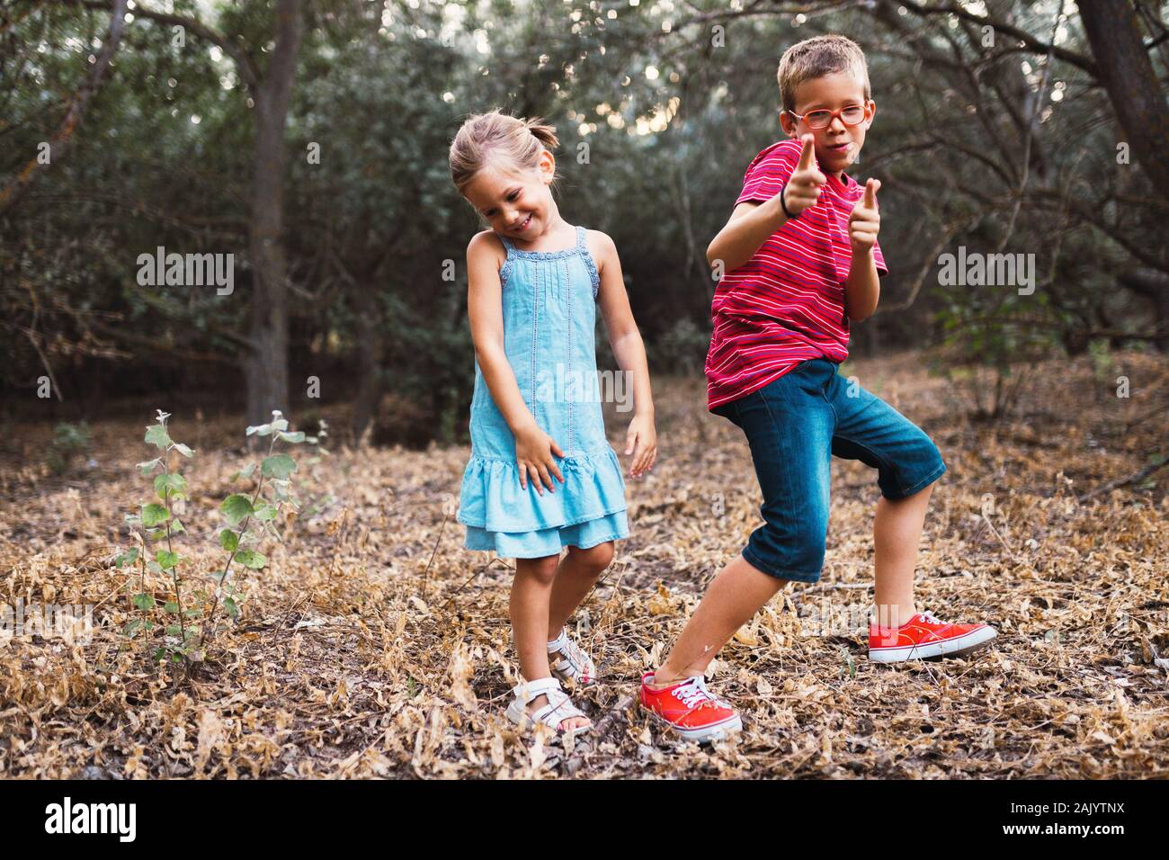 Two kids playing and dancing in the forest Stock Photo - Alamy