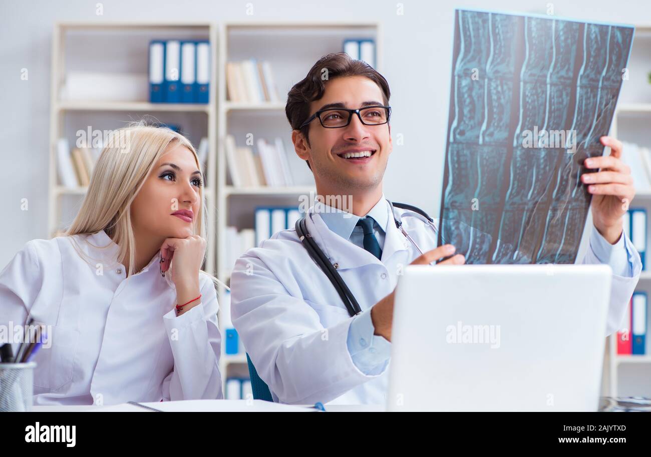 Two doctors examining x-ray images of patient for diagnosis Stock Photo ...