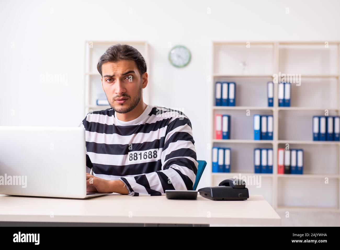 The young employee feeling like prisoner at work Stock Photo - Alamy