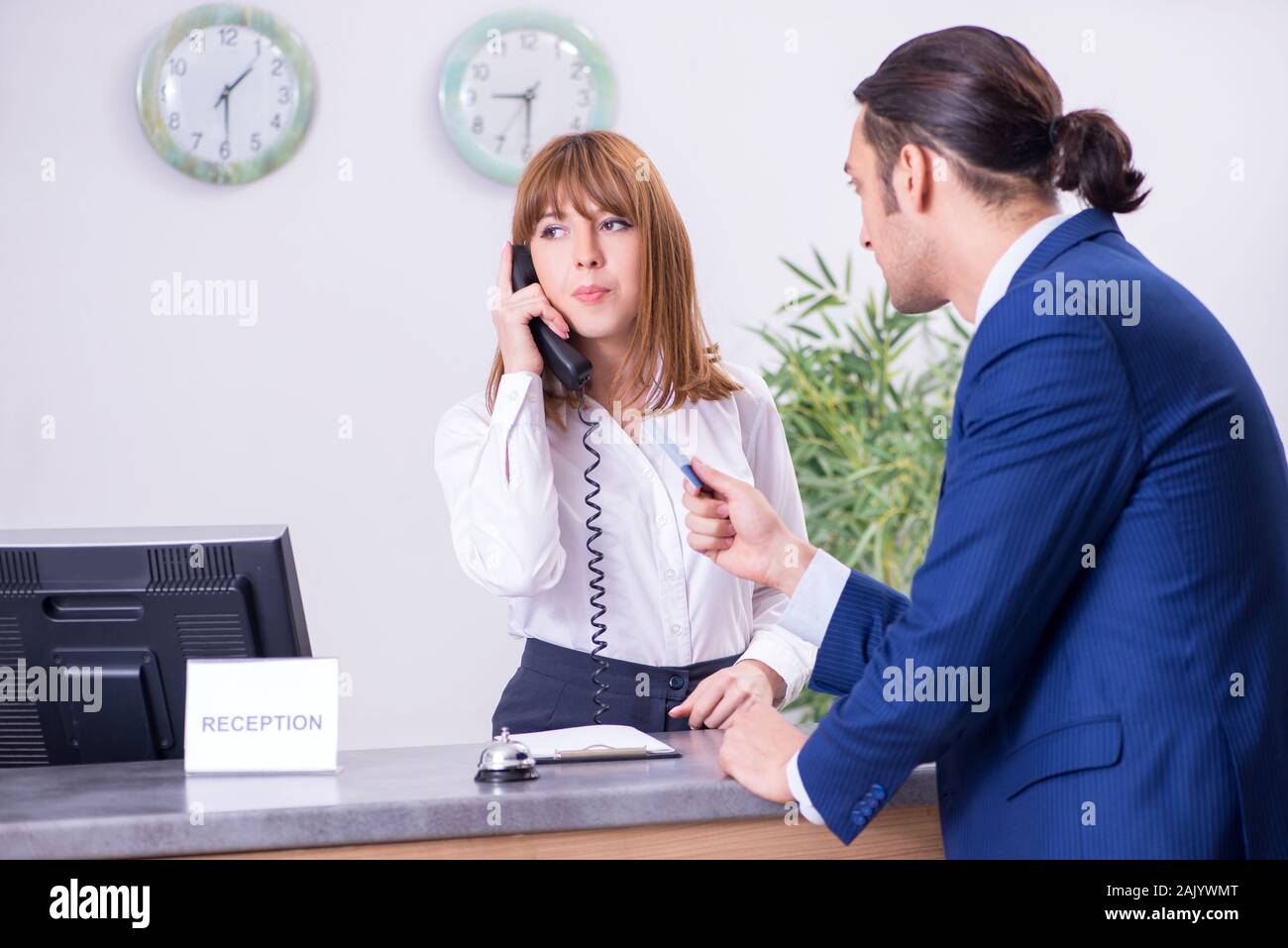 The young businessman at hotel reception Stock Photo - Alamy