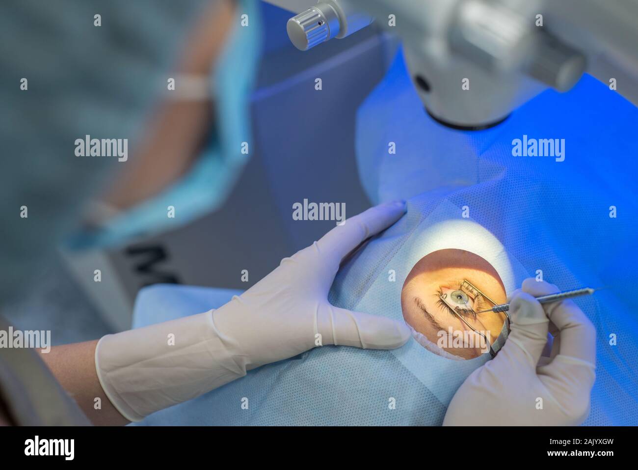 A close-up of the hands of an ophthalmologist surgeon looking through a ...