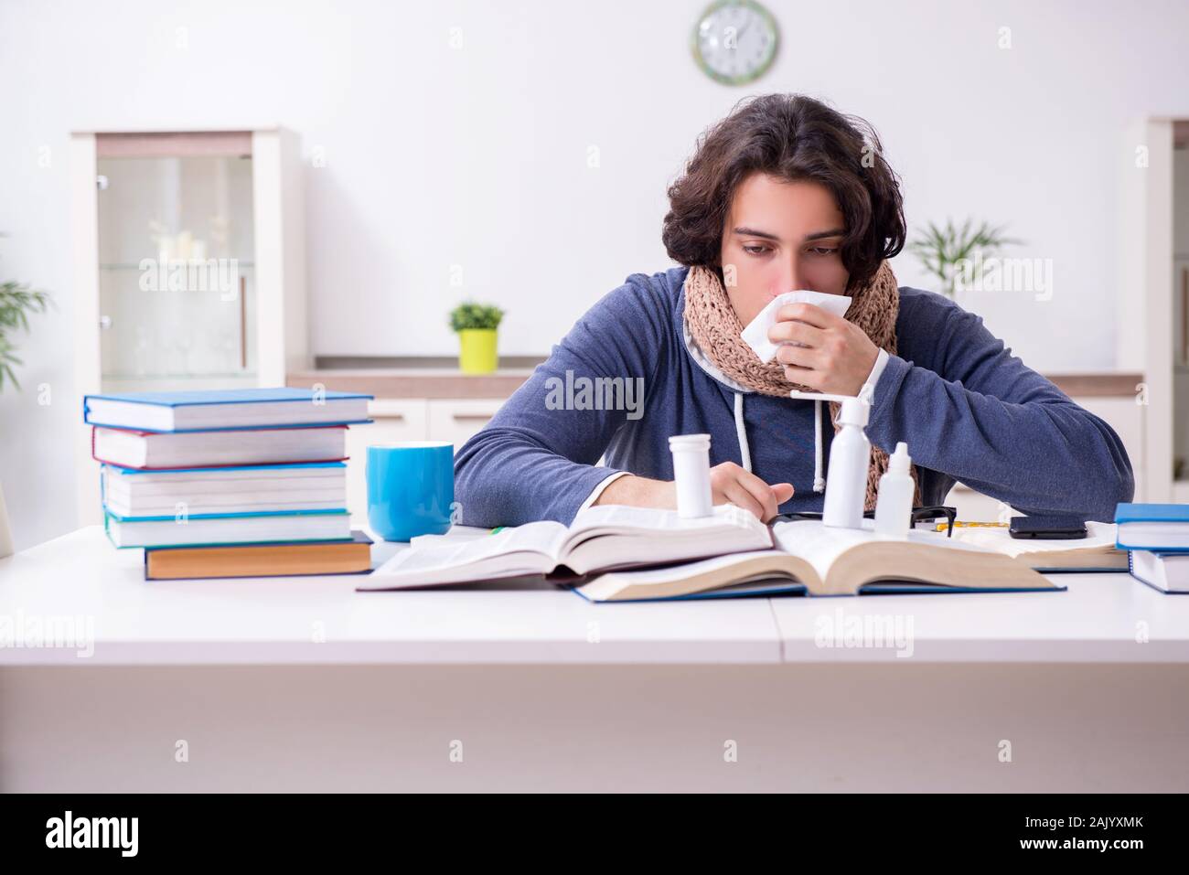 The sick male student suffering at home Stock Photo - Alamy