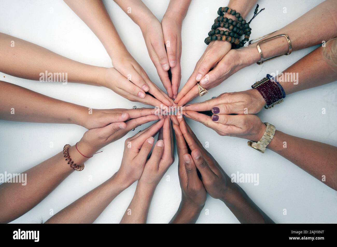 Women’s hands in a geometric connection design photographed on a white ...