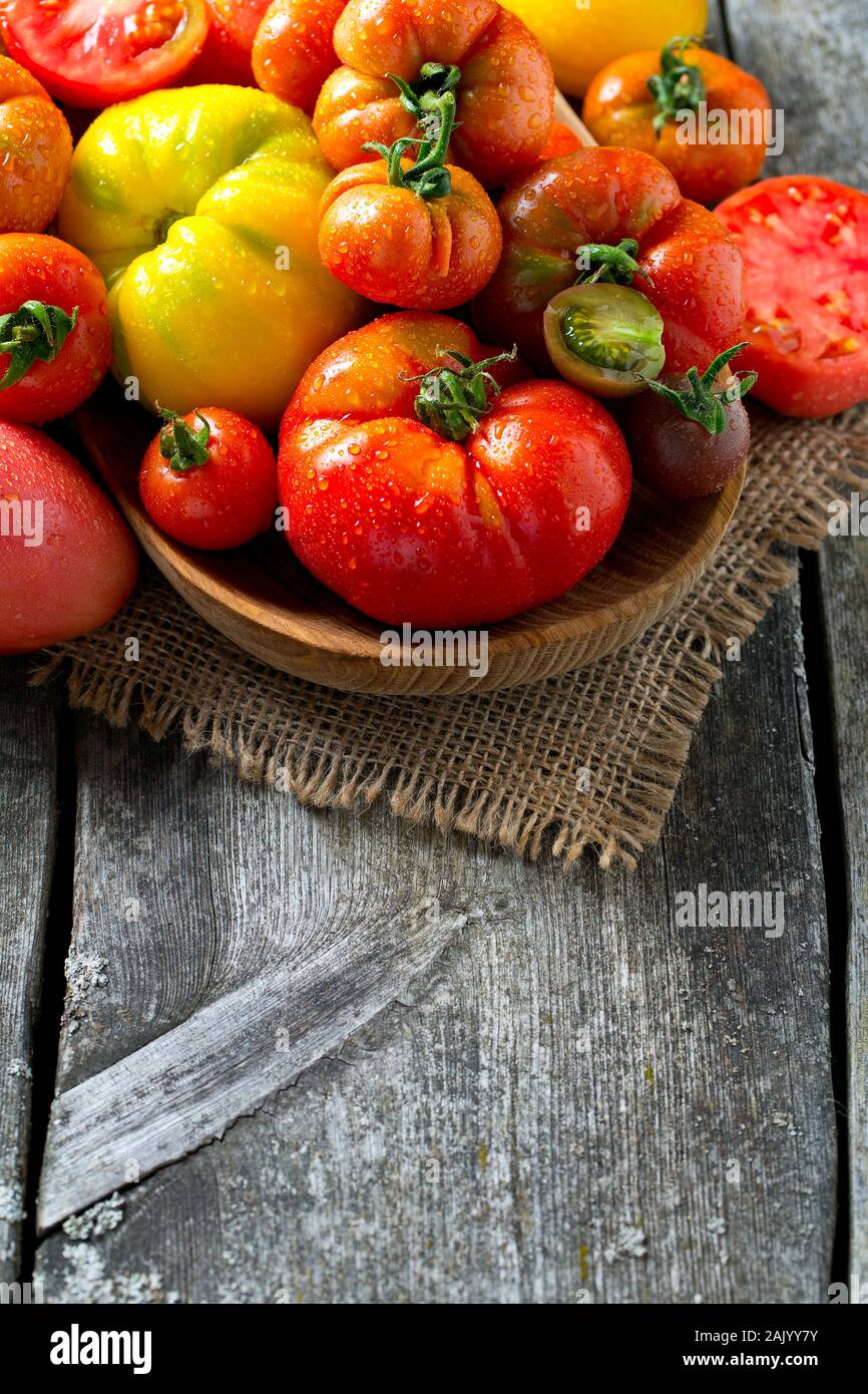 assorted tomatoes on wooden surface Stock Photo - Alamy