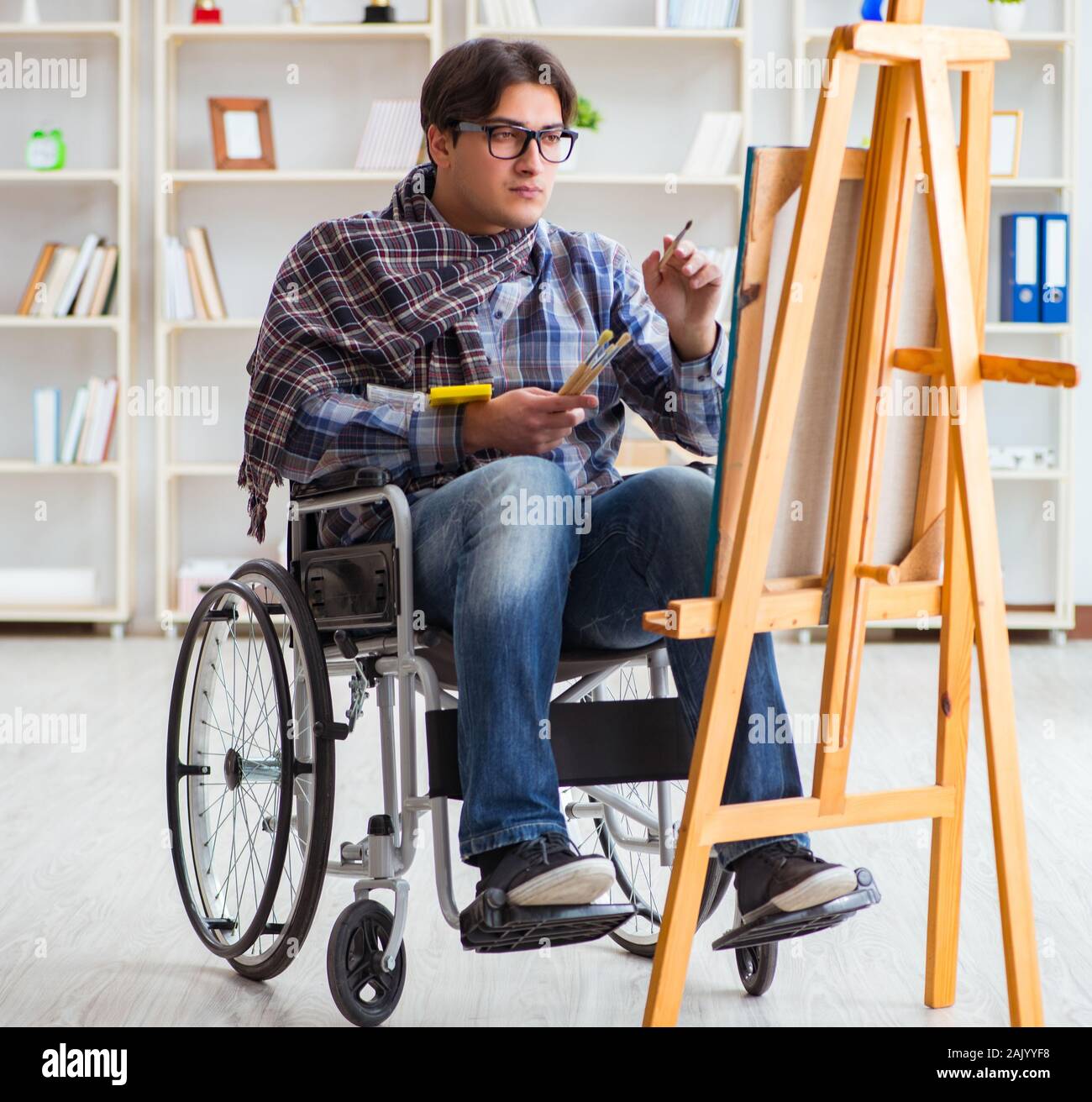 The disabled artist painting picture in studio Stock Photo - Alamy