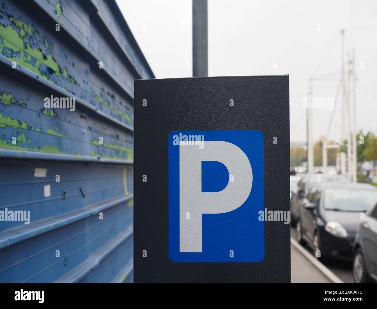 Parking meter with blue car park sign Stock Photo - Alamy