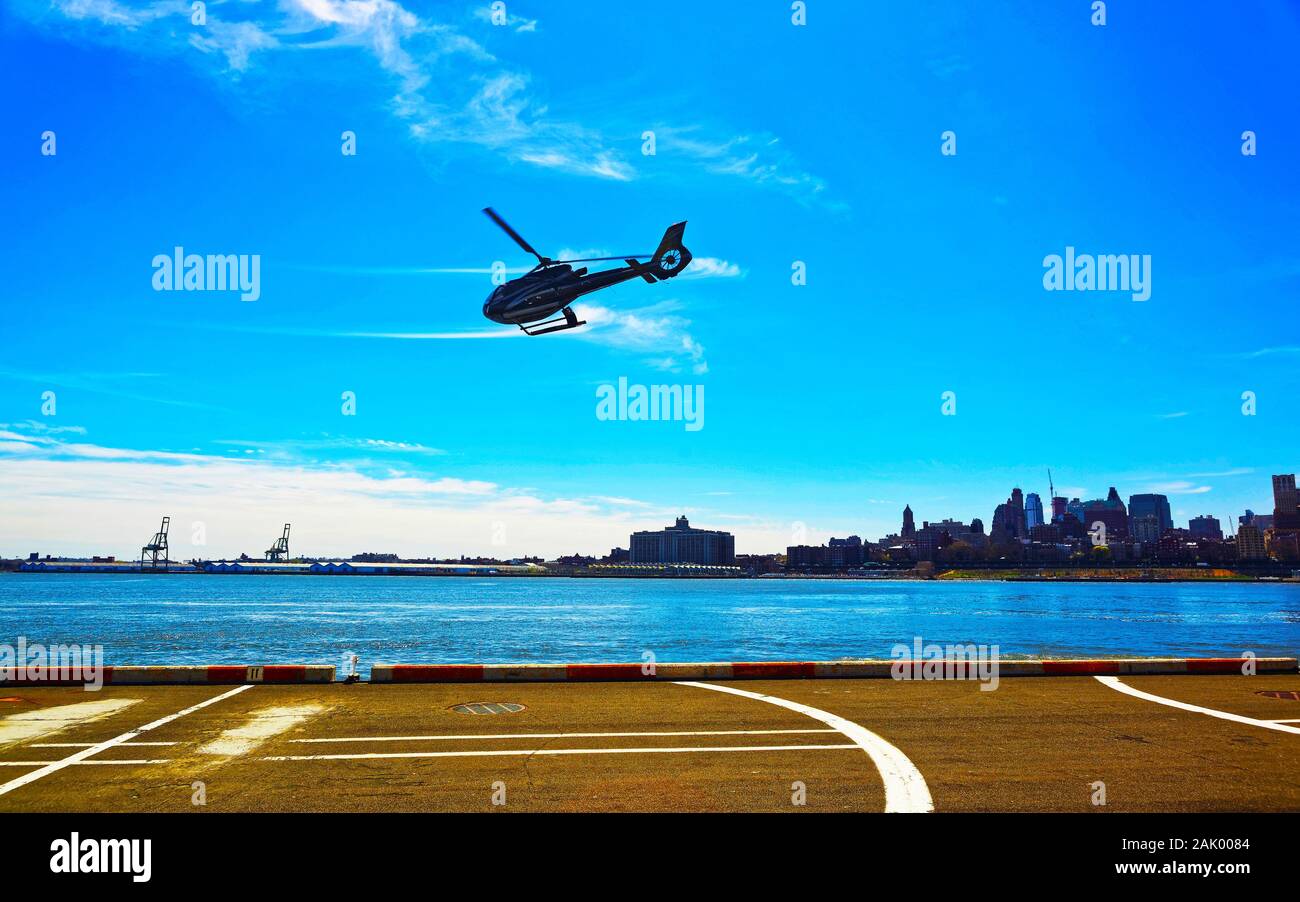 Black Helicopter over helipad in Lower Manhattan reflex Stock Photo - Alamy