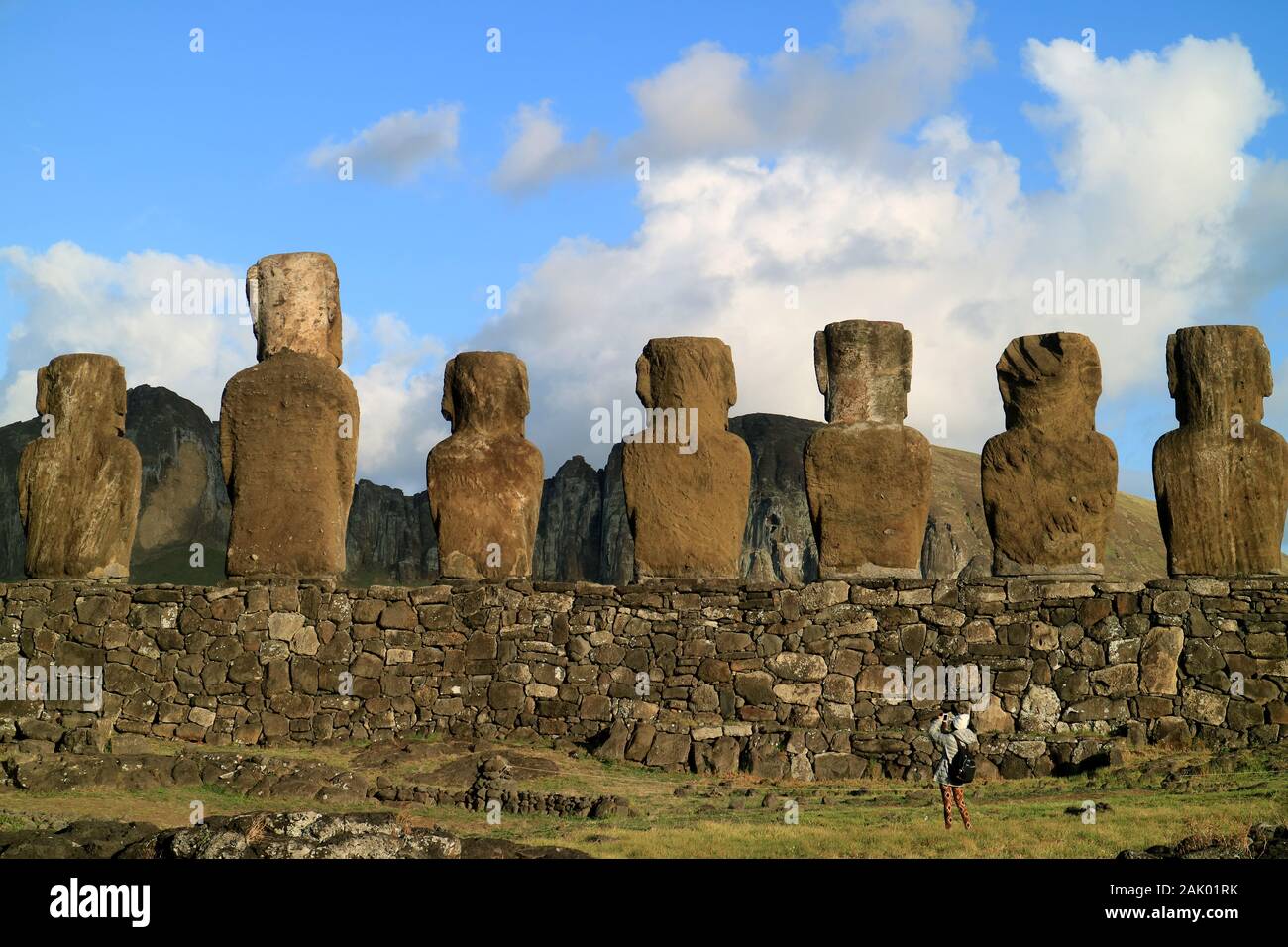 Female traveler photographing the back of gigantic Moai statues at Ahu ...