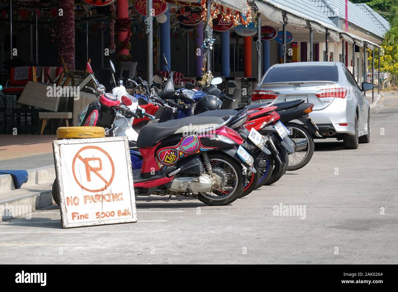 No parking sign and parked scooters and car Stock Photo - Alamy